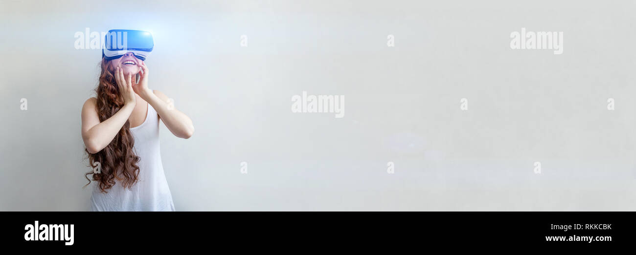 Technology, simulation, hi-tech, videogame concept. Young woman wearing using virtual reality VR ...