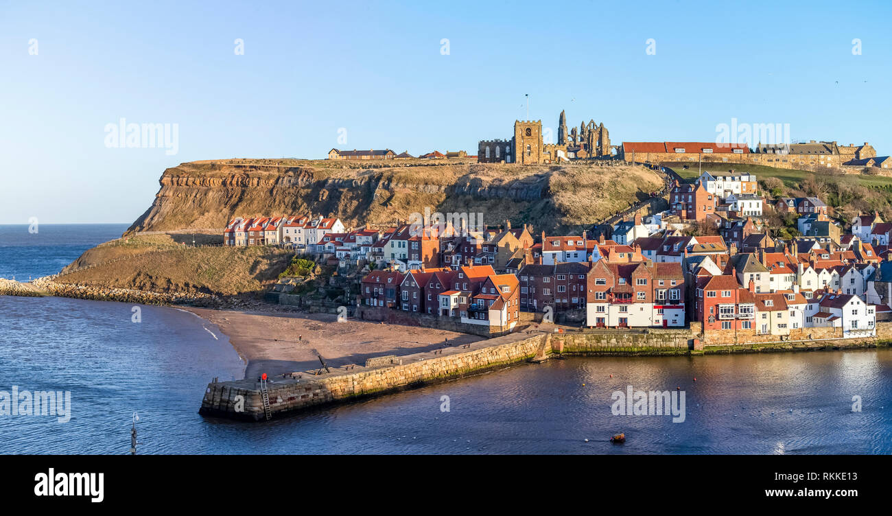 Whitby harbour and fishing port showing the Abbey and 12th century ...