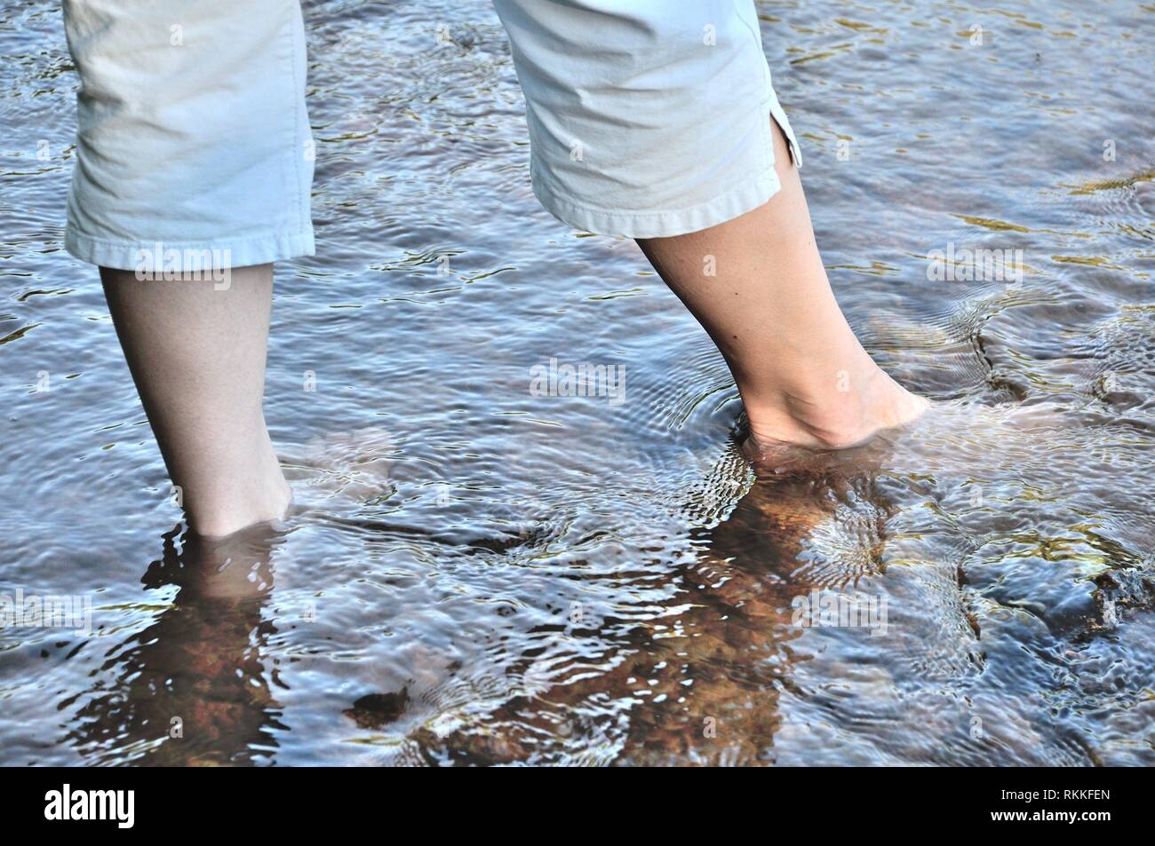 Woman walking by water hi-res stock photography and images - Alamy