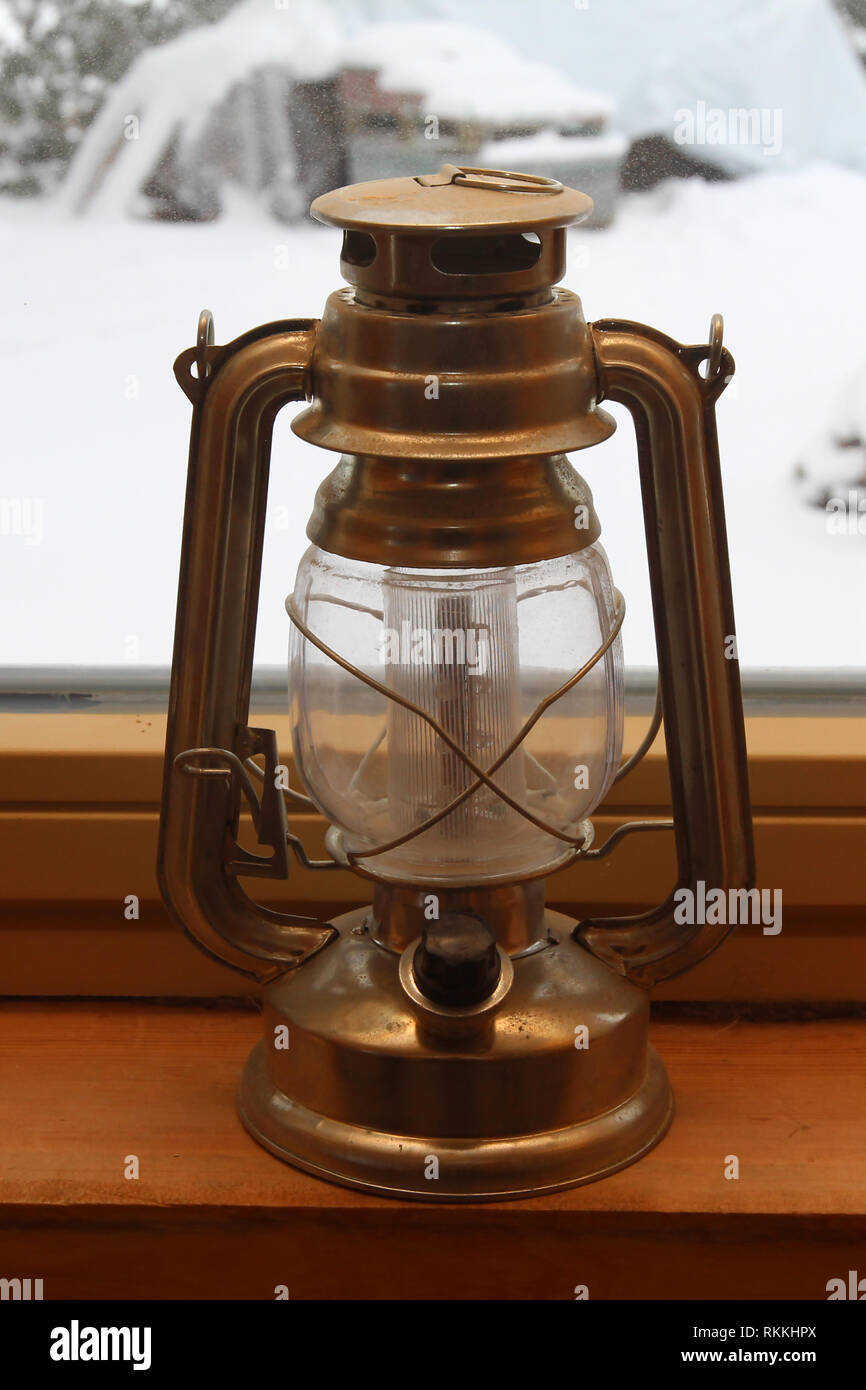 An old lamp standing on a windowsill Stock Photo - Alamy