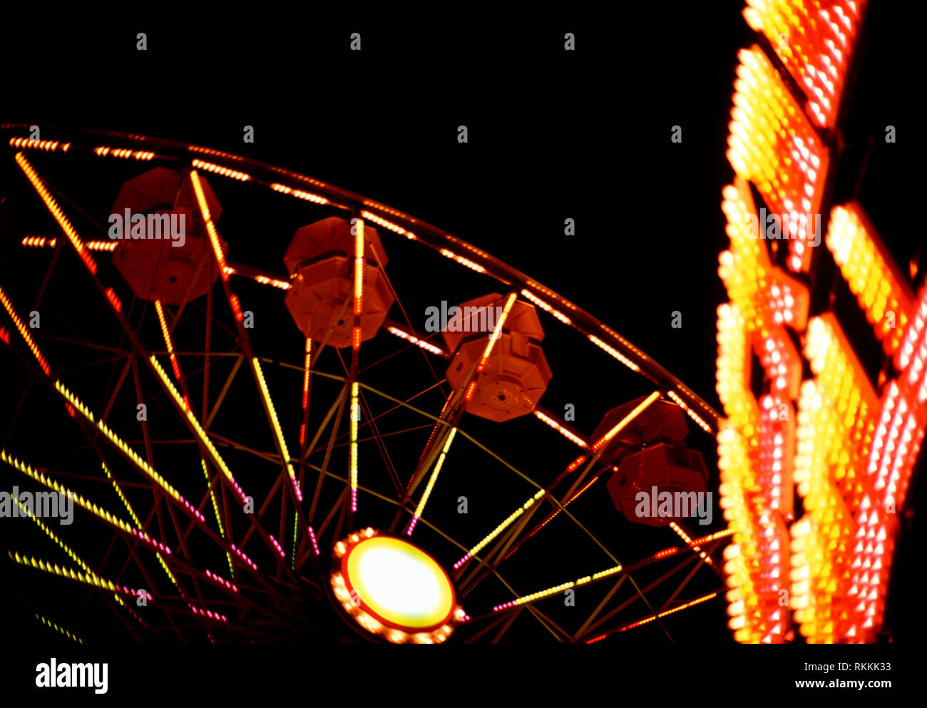Illuminated amusement park rides at night Stock Photo - Alamy