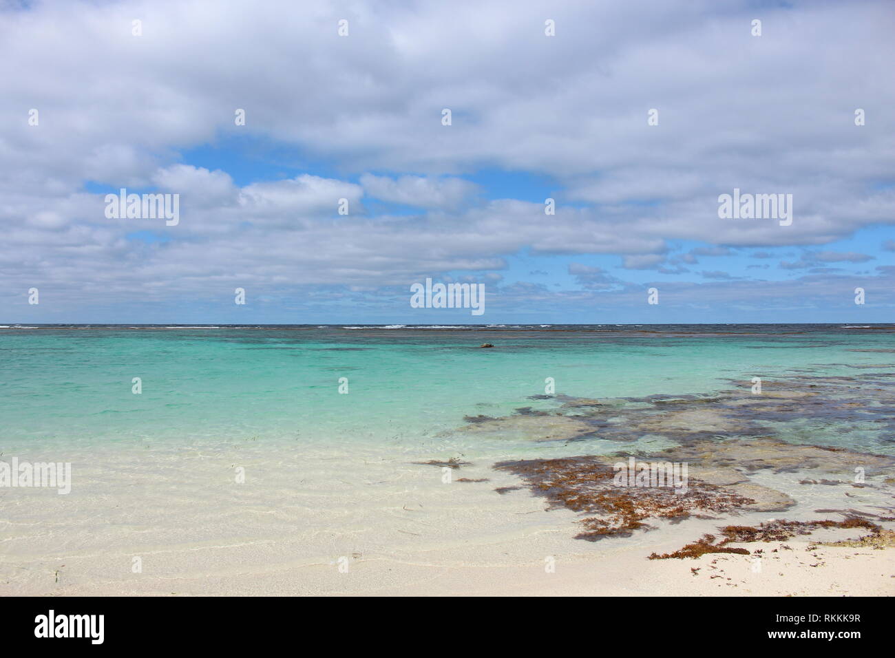 Beautiful calm open sea with blue cloudy sky on the coast of Rottnest ...