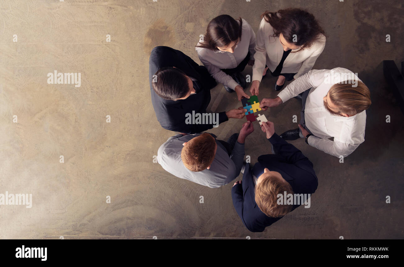 Teamwork of partners. Concept of integration and startup with puzzle ...