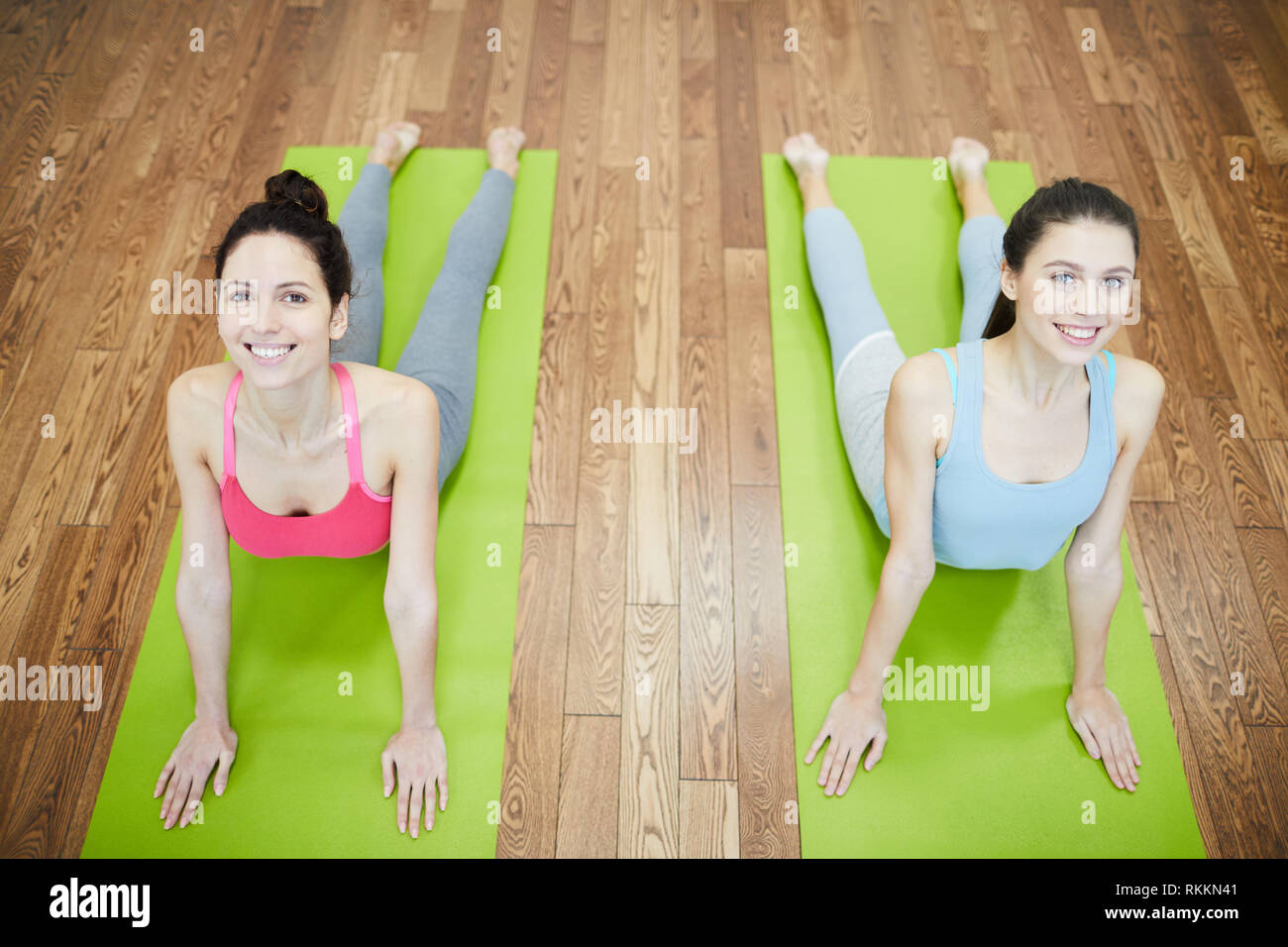 Smiling young women stretching hi-res stock photography and images - Alamy