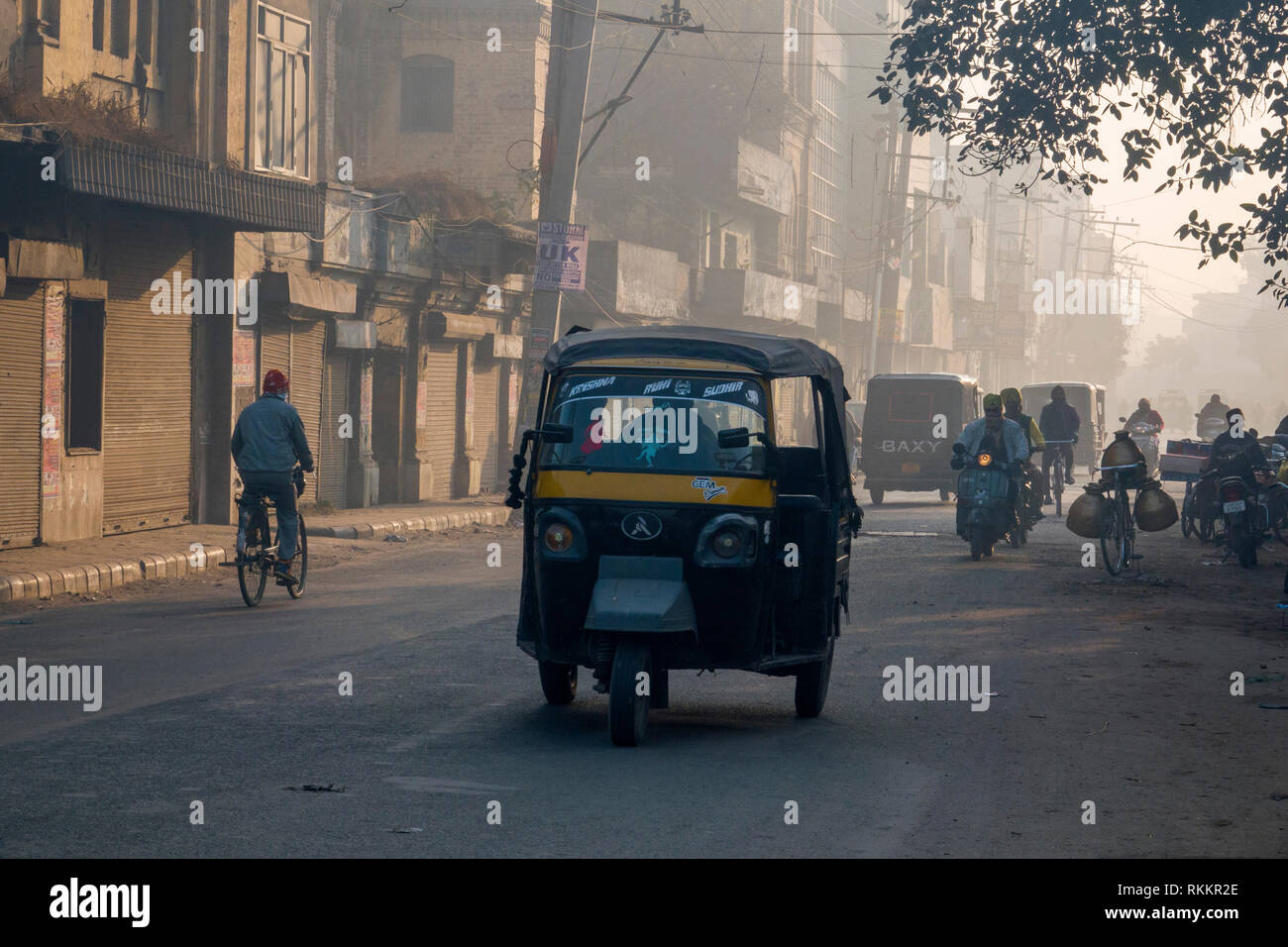 Auto rickshaws and other traffic on city street in Amritsar, India ...