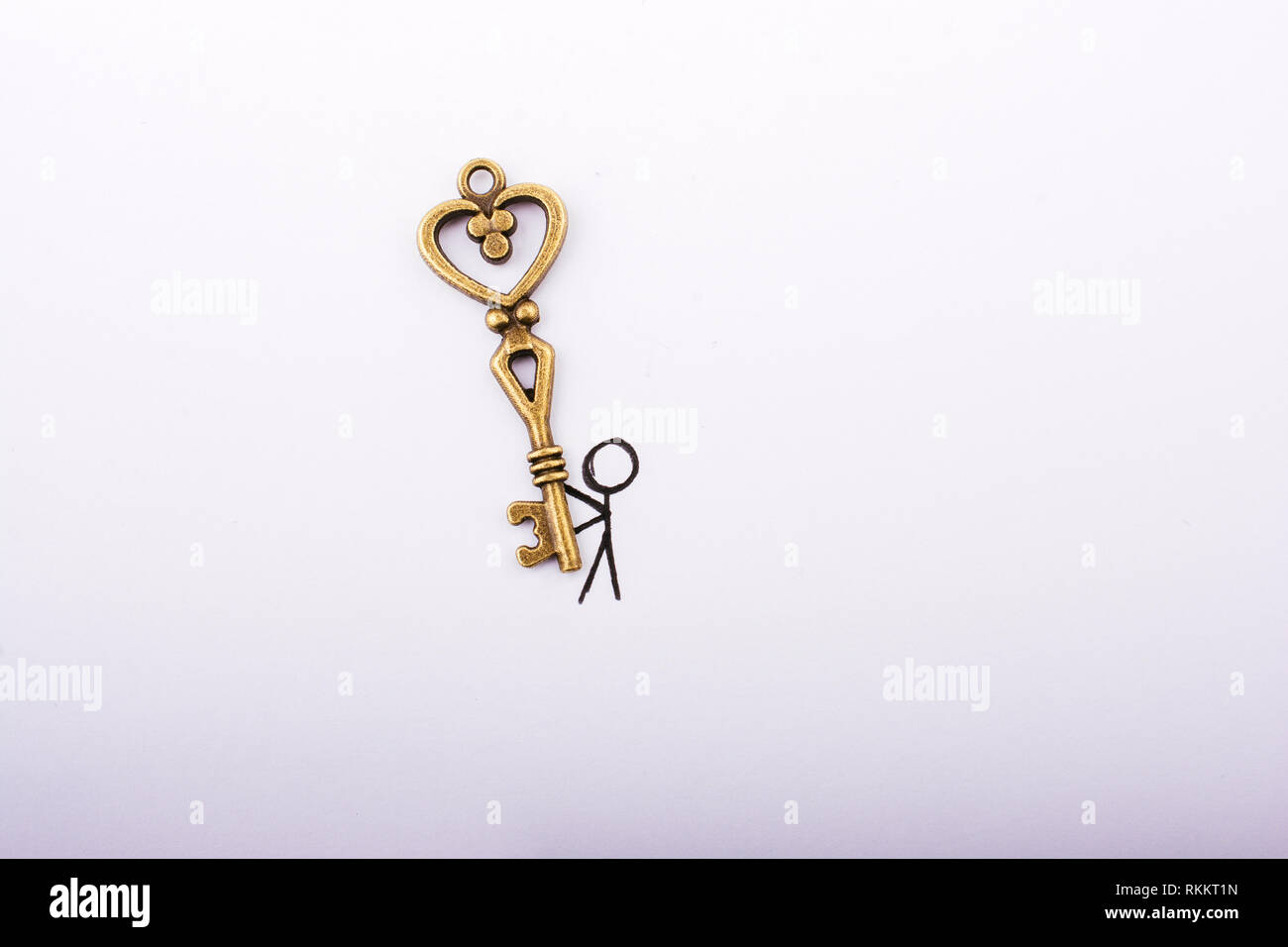 Man carrying a heart shaped key on white background Stock Photo - Alamy