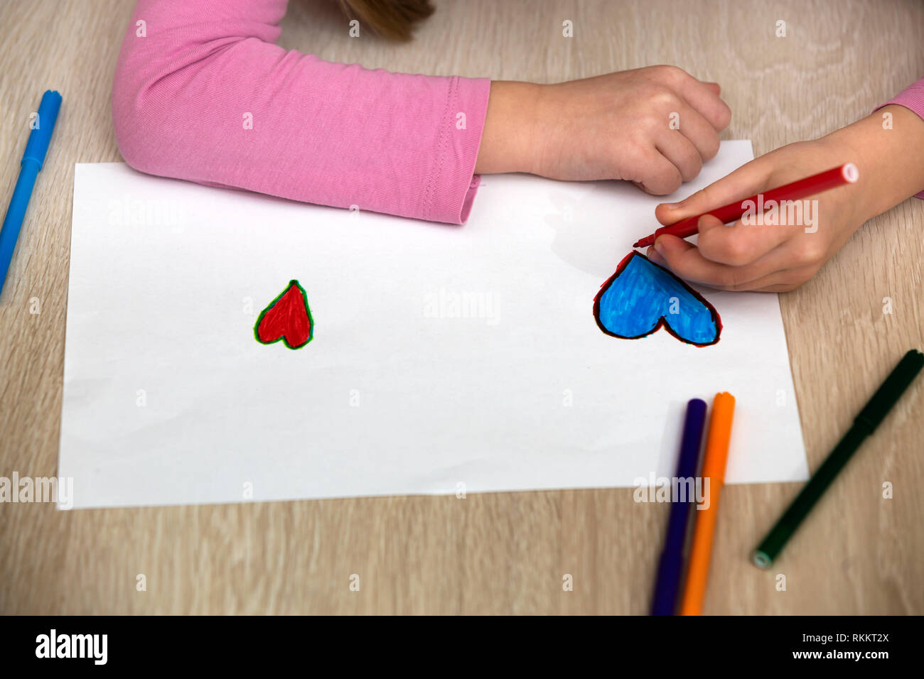 Child girl hands drawing with colorful pencils crayons heart on white ...