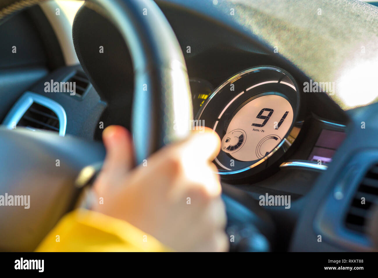 Modern car interior with driver hand on steering wheel. Safe driving ...
