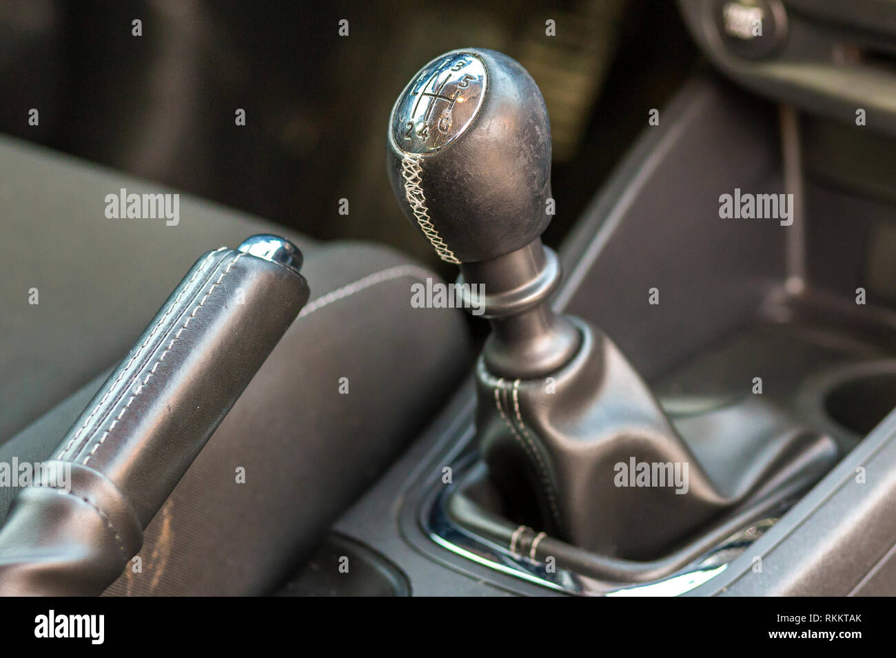 Luxurious car black leather interior. Close-up detail of handbrake ...