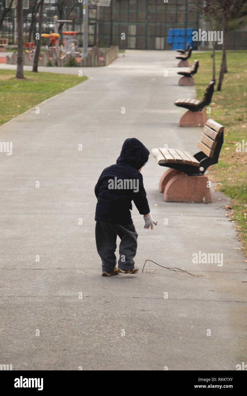 Child walking wooden park bench at a park Stock Photo - Alamy