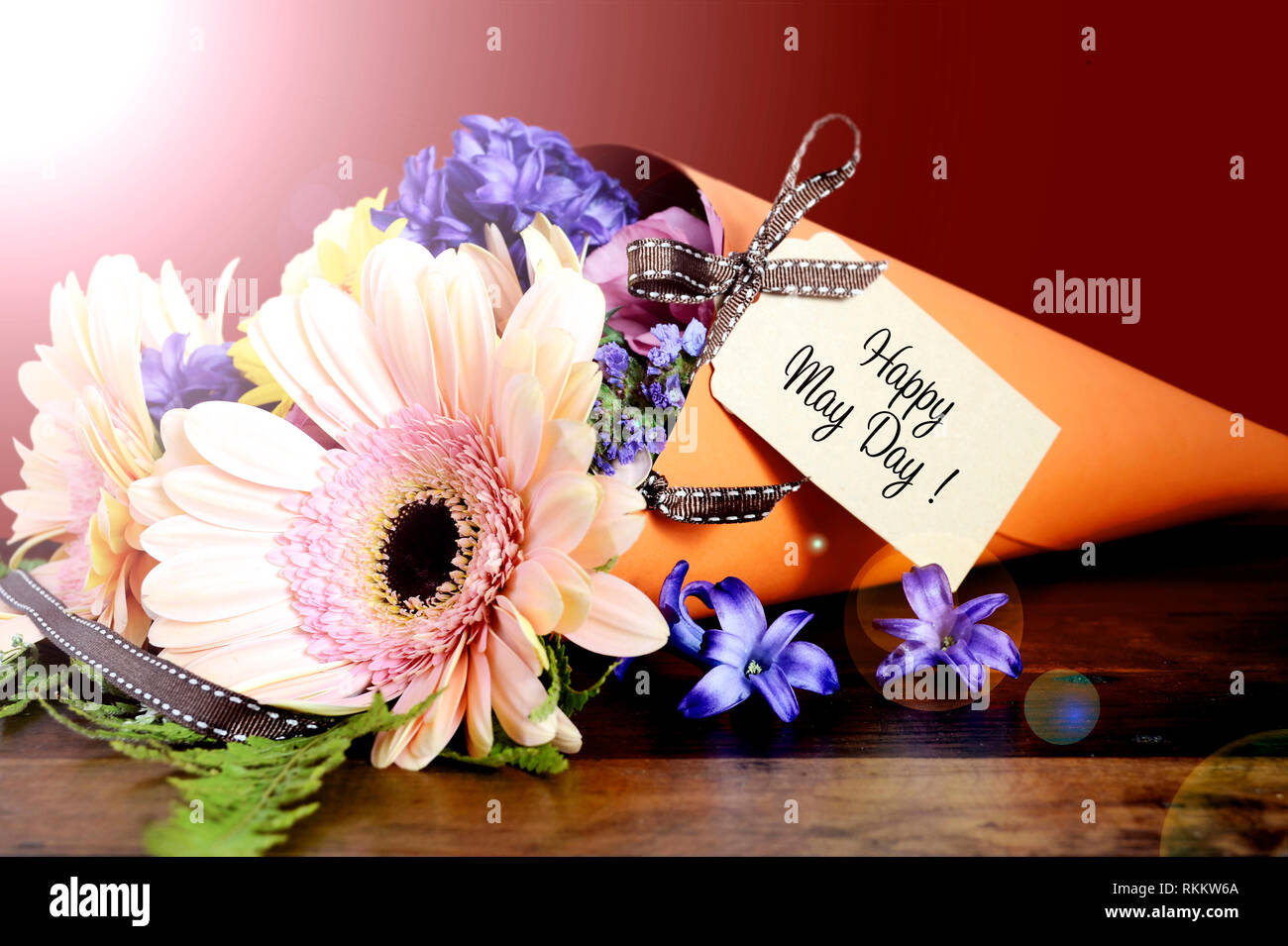 Happy May Day traditional gift of Spring Flowers in orange paper cone ...