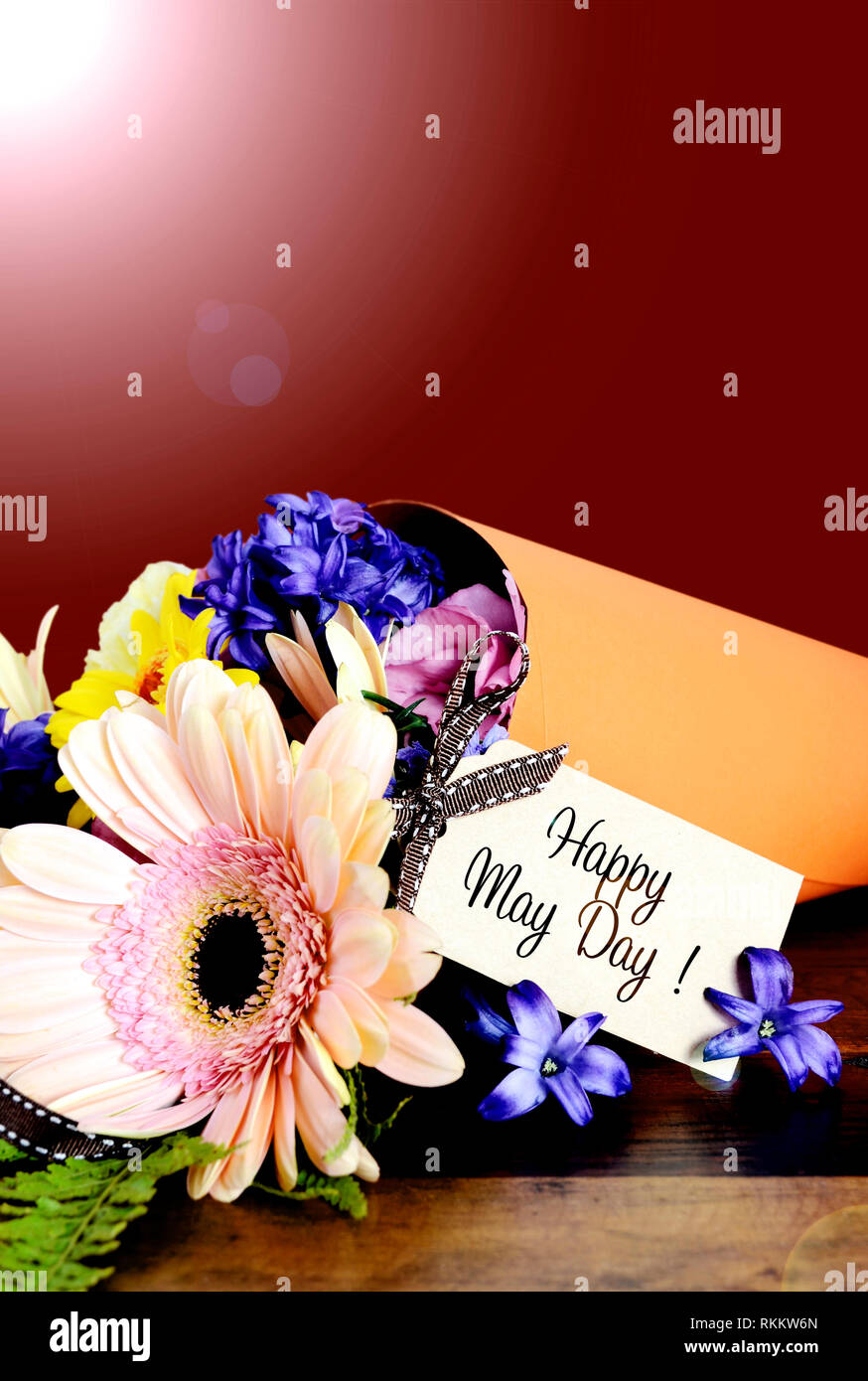 Happy May Day traditional gift of Spring Flowers in orange paper cone ...