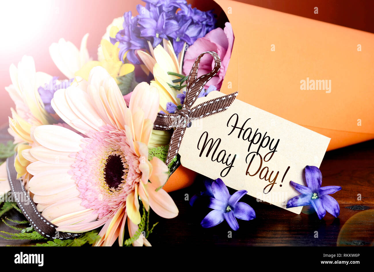 Happy May Day traditional gift of Spring Flowers in orange paper cone ...
