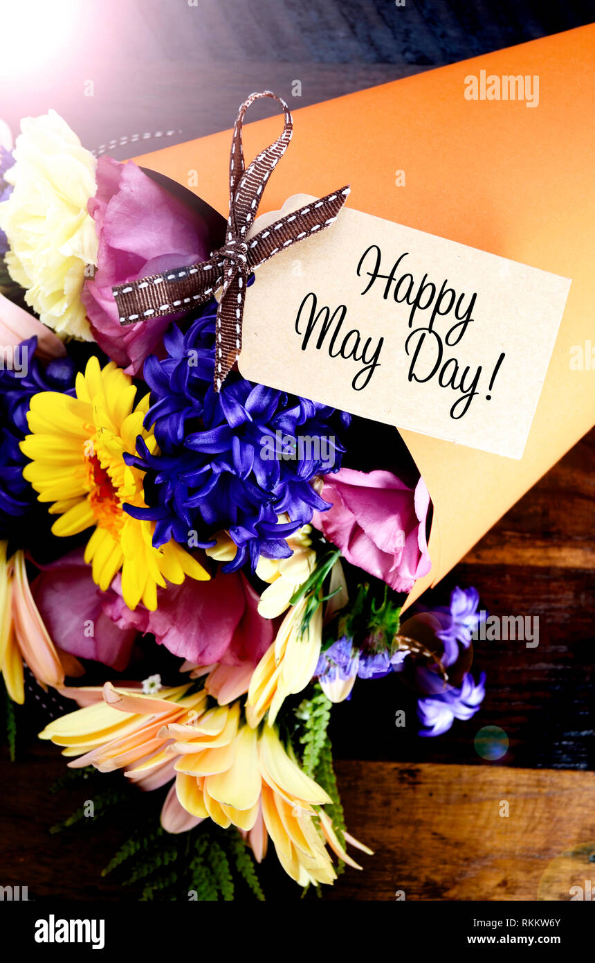 Happy May Day traditional gift of Spring Flowers in orange paper cone ...