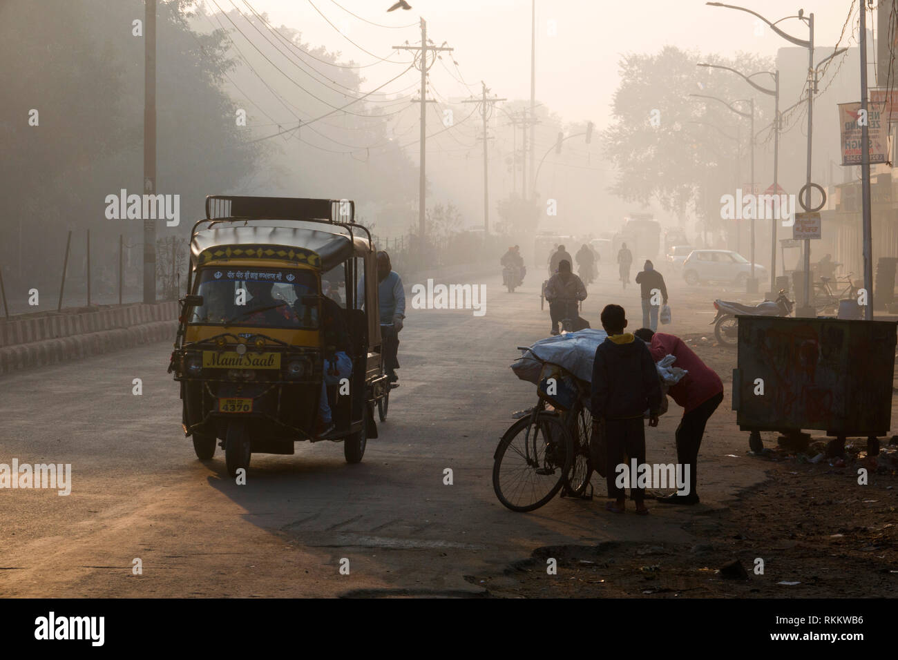 Auto rickshaws and other traffic on city street in Amritsar, India ...