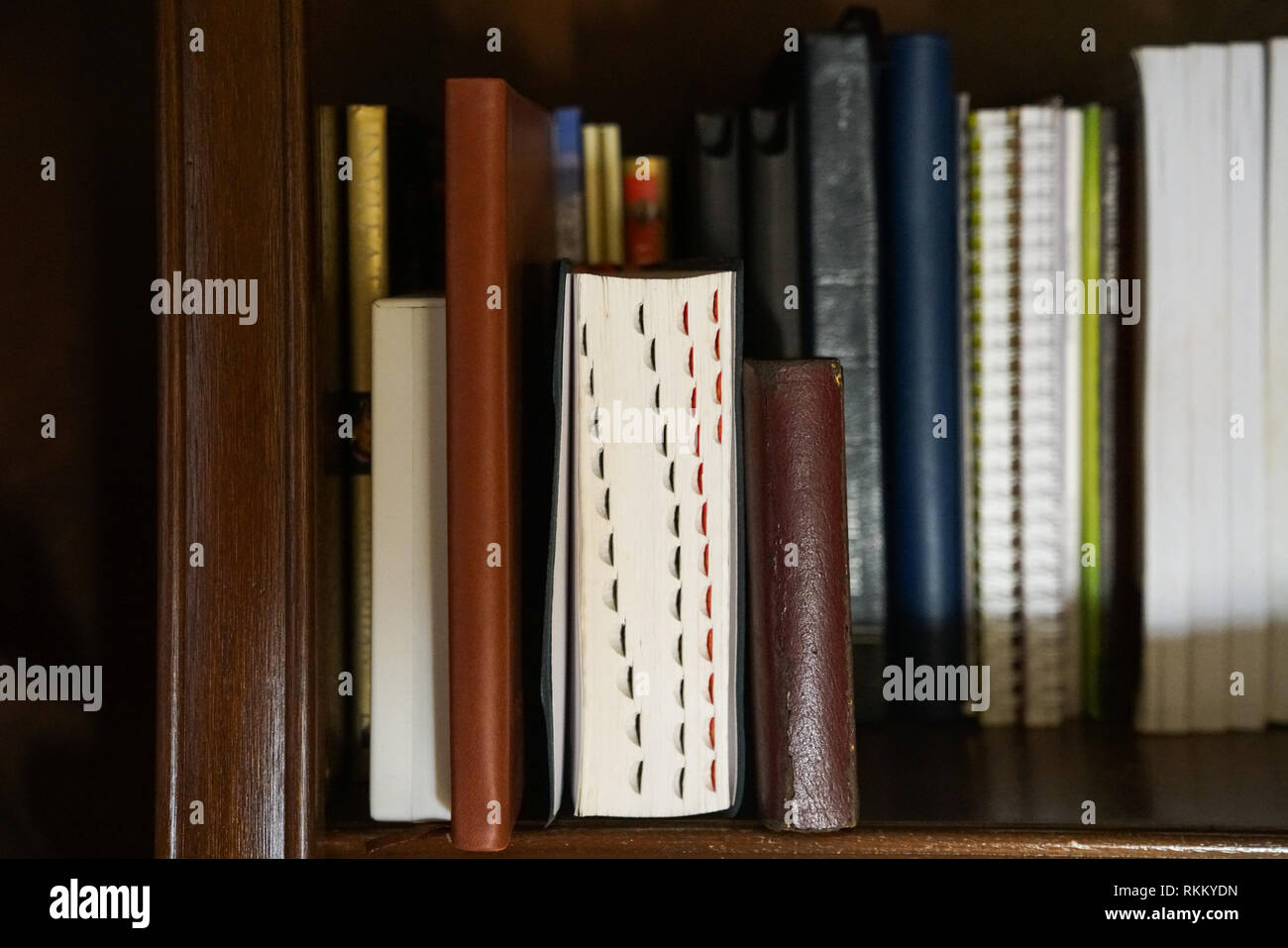 Books stacked on book shelves Stock Photo - Alamy