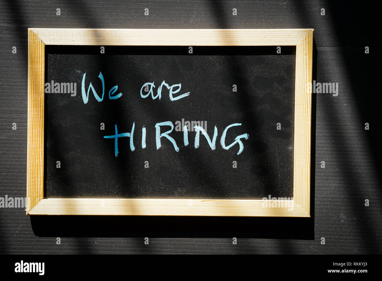 We are hiring written on a black board with chalk Stock Photo - Alamy