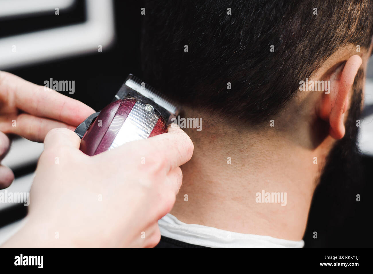 Master cuts hair and beard of men in the barbershop, hairdresser Stock ...