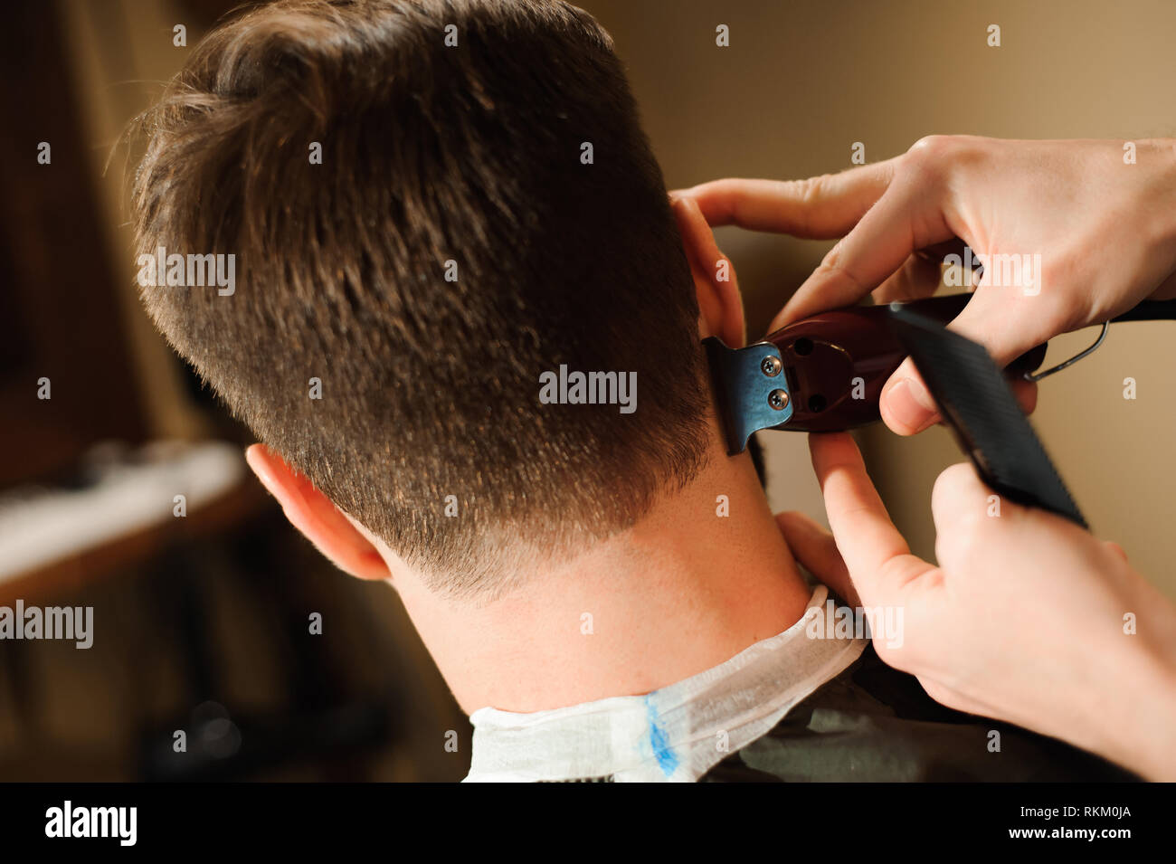 Master cuts hair and beard of men in the barbershop Stock Photo - Alamy