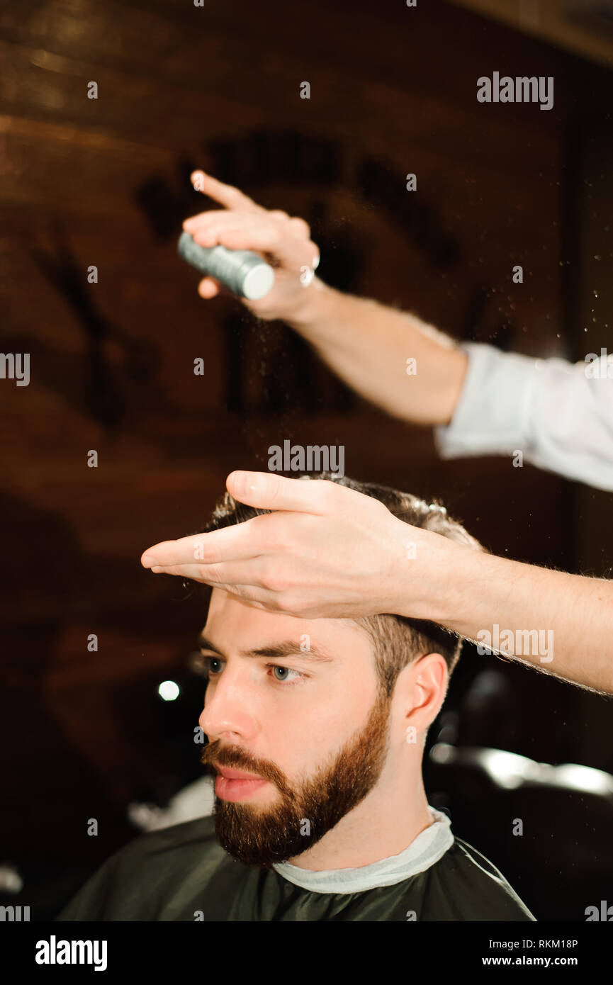 Master cuts hair and beard of men in the barbershop Stock Photo - Alamy