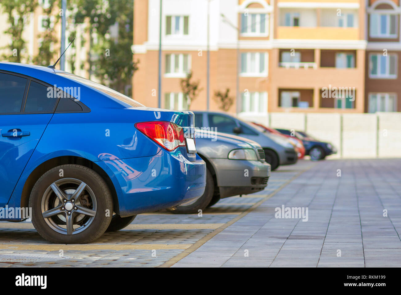 Side view detail of cars row parked in paved yard parking lot area on ...