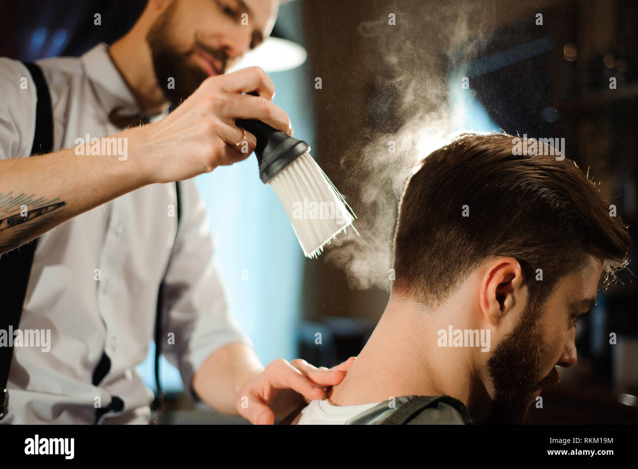 Master cuts hair and beard of men in the barbershop Stock Photo - Alamy