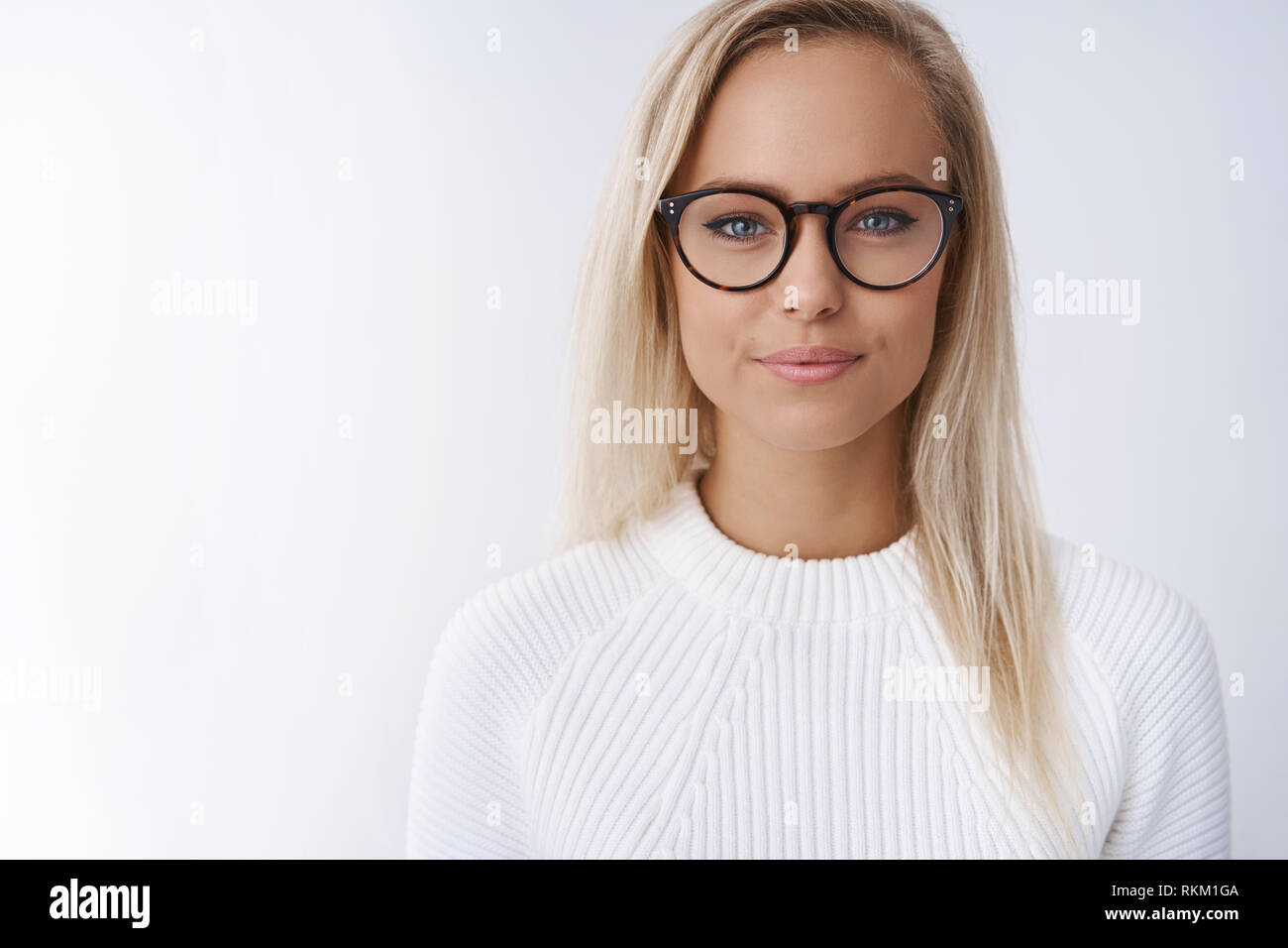 Close-up shot of charming pleasant and friendly-looking blond female ...