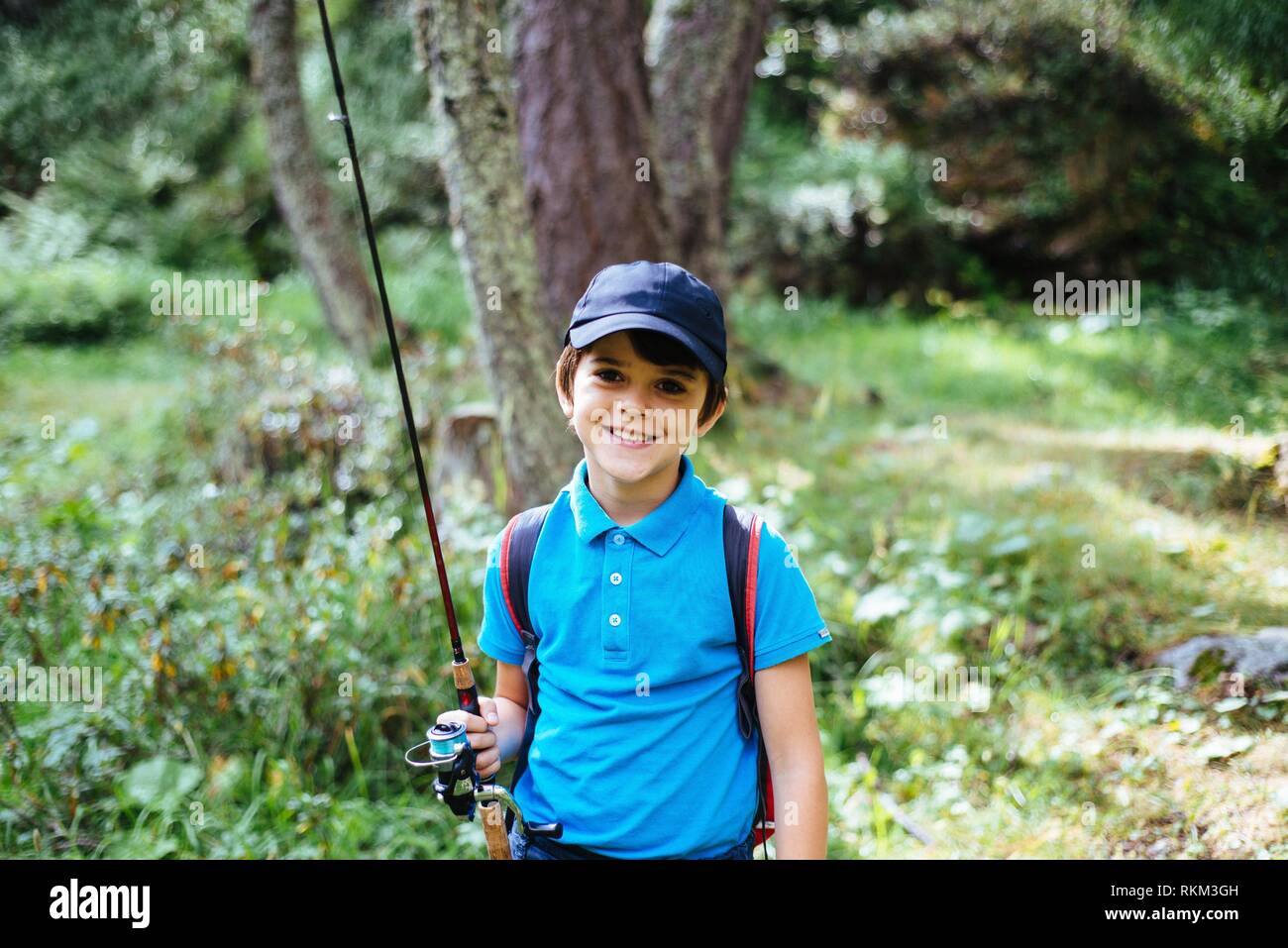 portrait of child with fishing rod in the mountains in the alps Stock ...