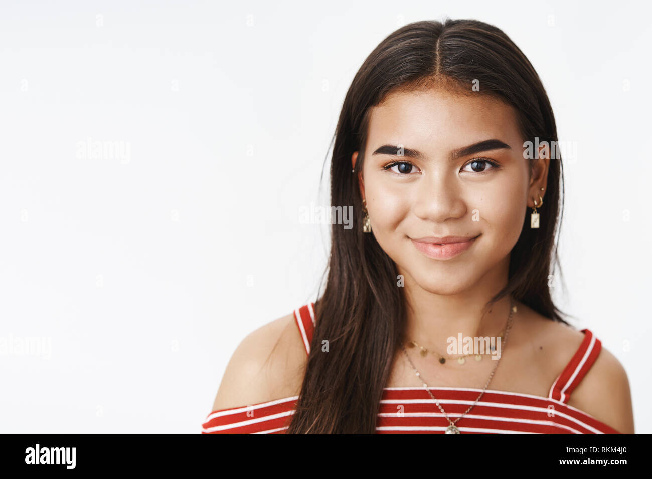 Headshot of charming friendly-looking young indian girl with long dark ...