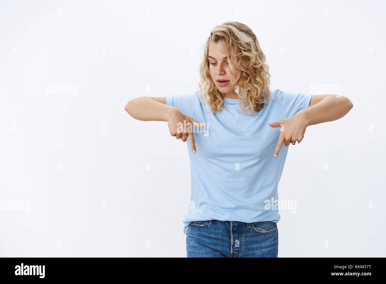 Woman cannot hide excitement and interest as looking and pointing down ...
