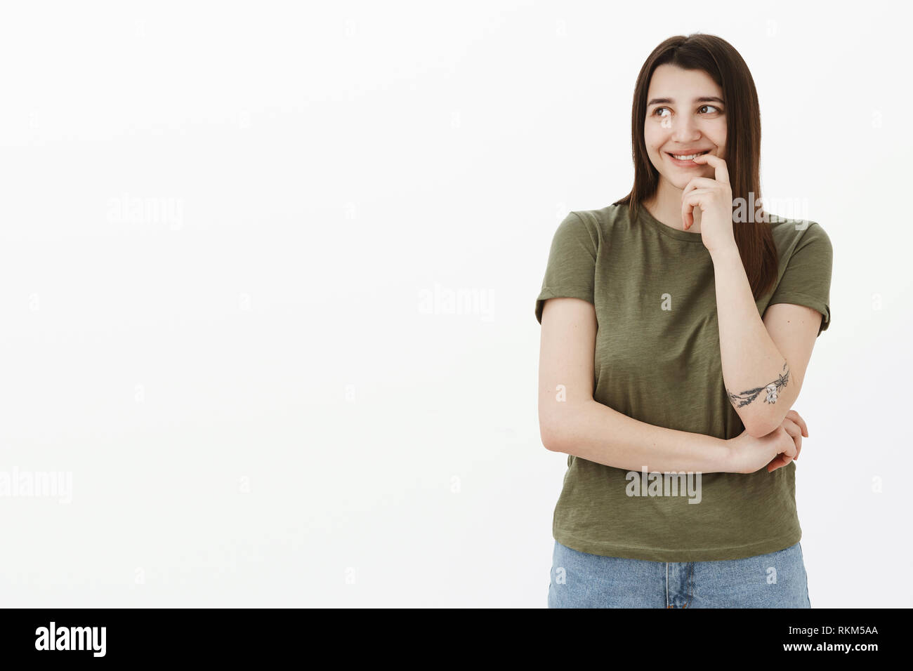 Dreamy and sensual cute ordinary brunette female with tattoo and brown ...