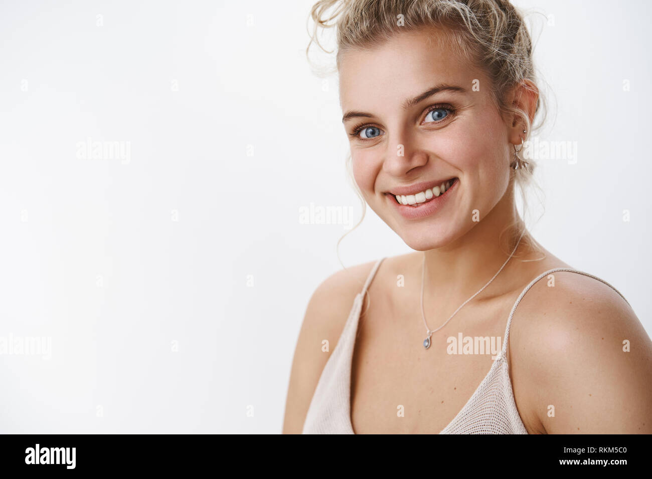 Sincere delighted feminine blond girl with blue eyes and nice happy ...