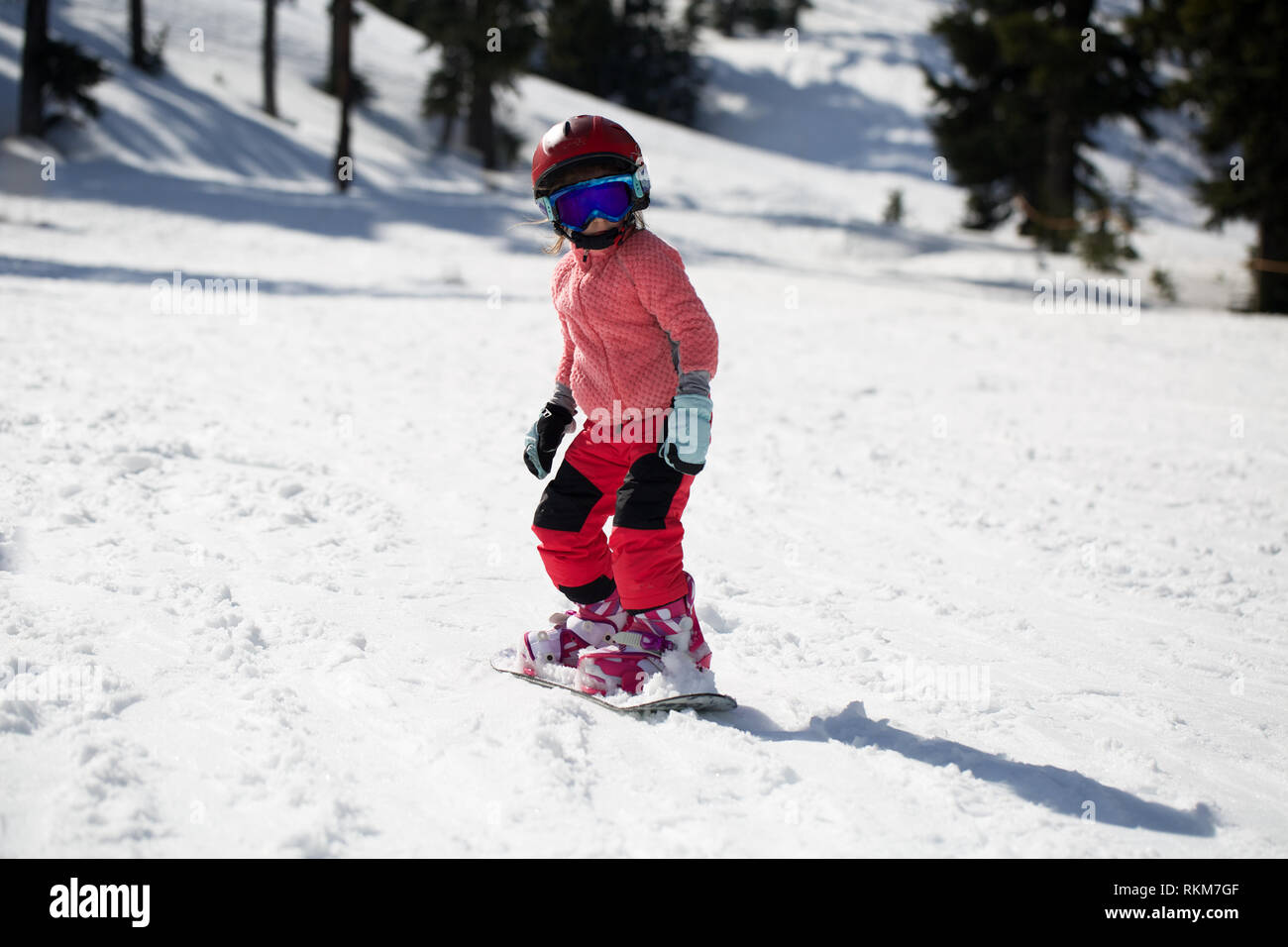 Little Cute 5 Years Old Girl Snowboarding making a Tricks at Ski Resort ...