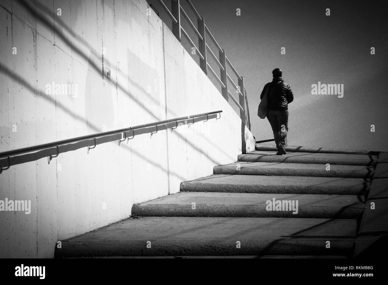 Person climbing the stairs hi-res stock photography and images - Alamy