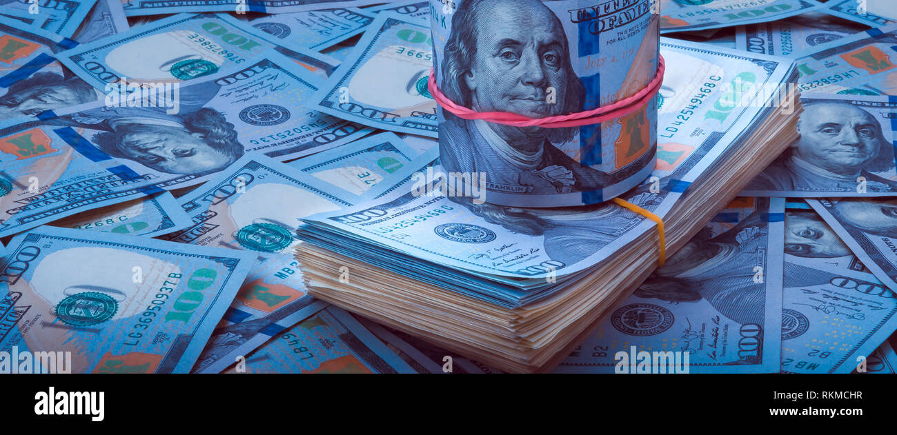 Stack of dollars, the roll of dollars on the background of hundred ...