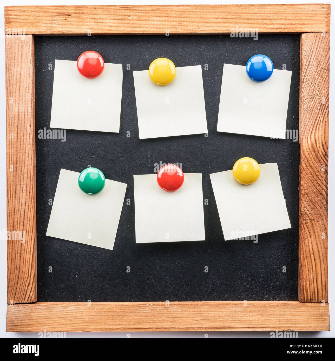 Blackboard and post-it notes stuck with colorful magnets Stock Photo ...