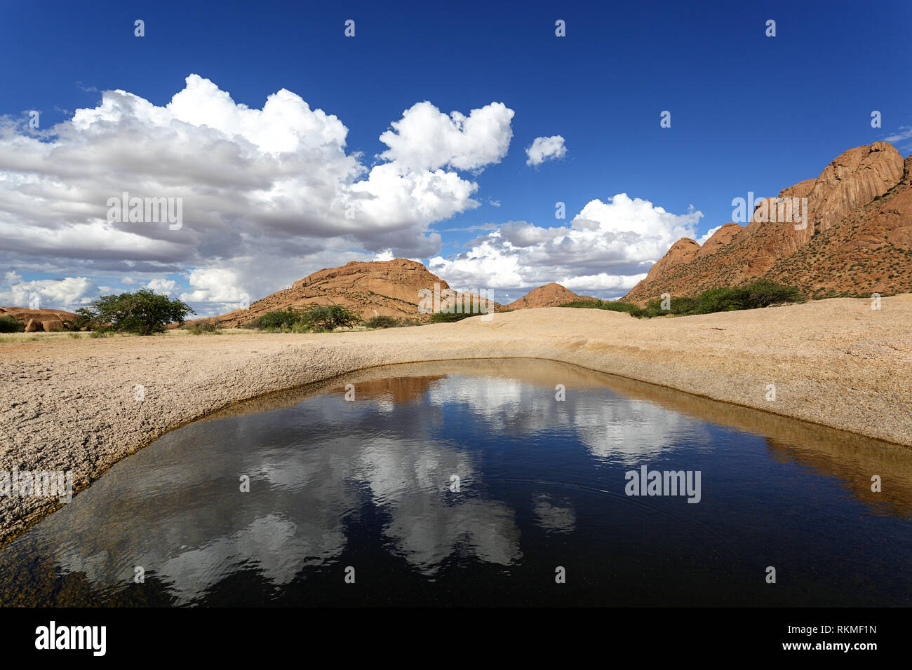 Reflection of clouds in the natural pool at the natural rock arch near ...