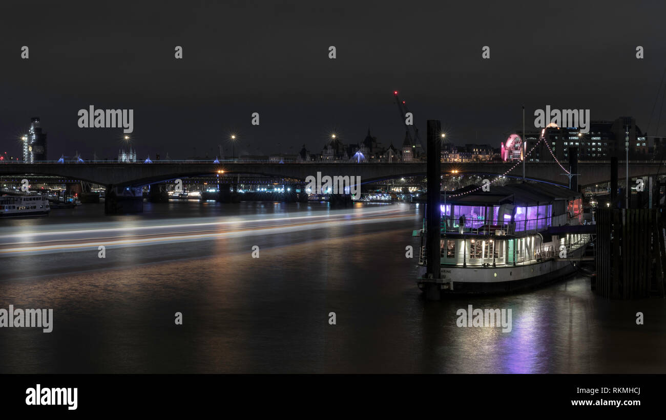 Riverside near Waterloo Bridge at night in London. Some lines drawn by ...