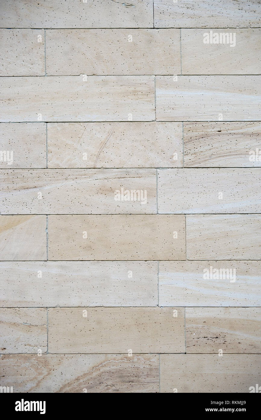 A light beige cladding made of marbled sandstone with pores Stock Photo ...
