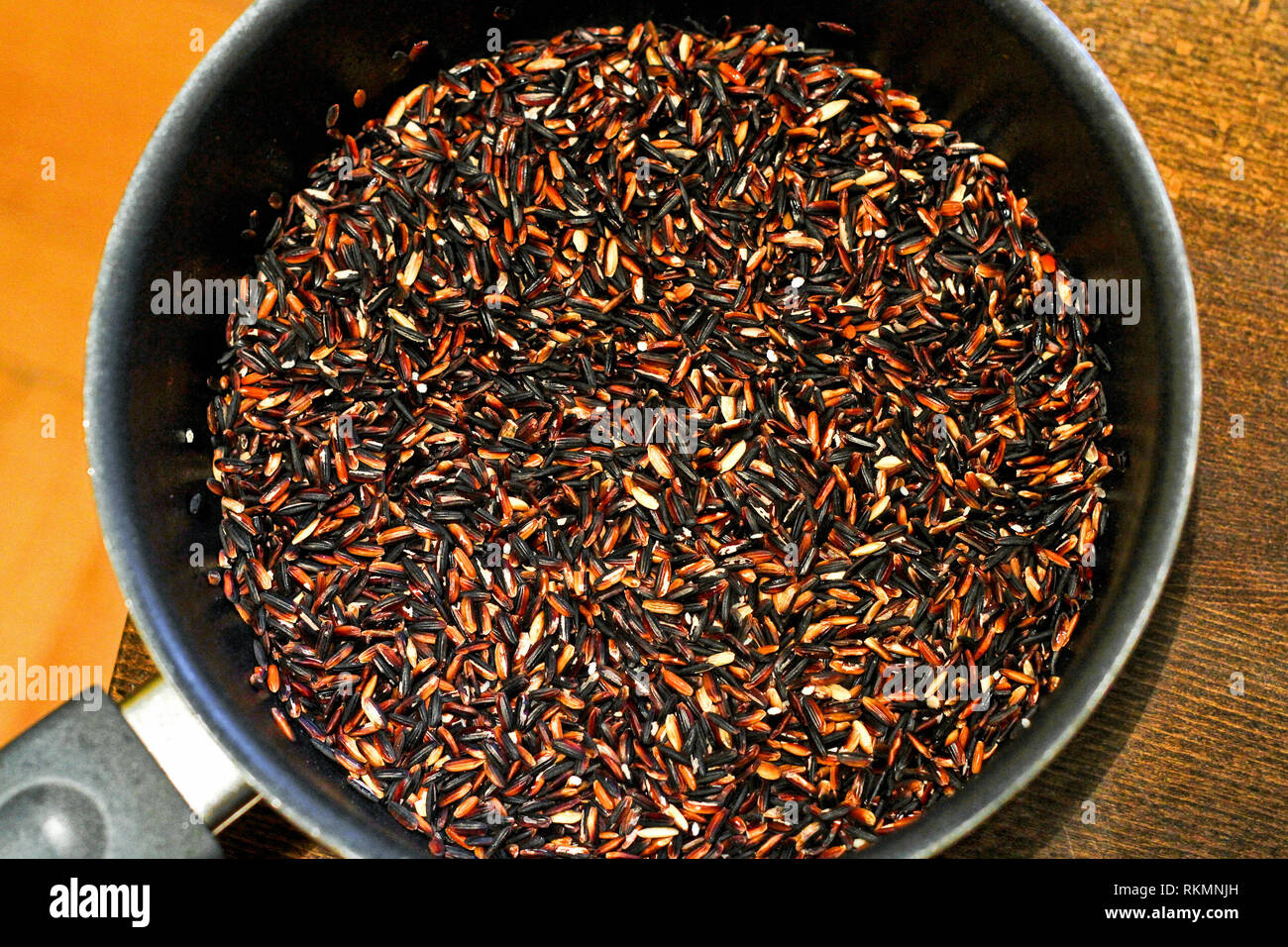 Big pot of whole black organic rice Stock Photo - Alamy