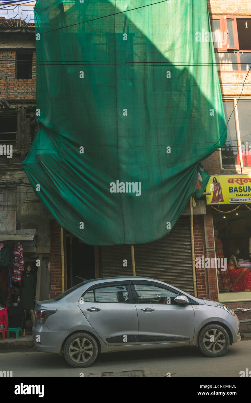 A green cloth covering the scaffoldings Stock Photo - Alamy