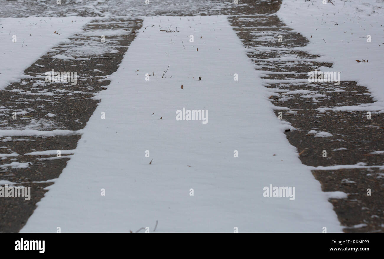 Driveway with snow in the yard between the tire tracks Stock Photo - Alamy