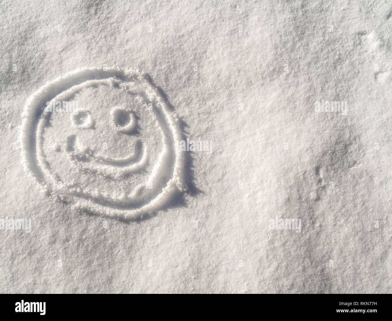 Smiley face drawn in snow hi-res stock photography and images - Alamy