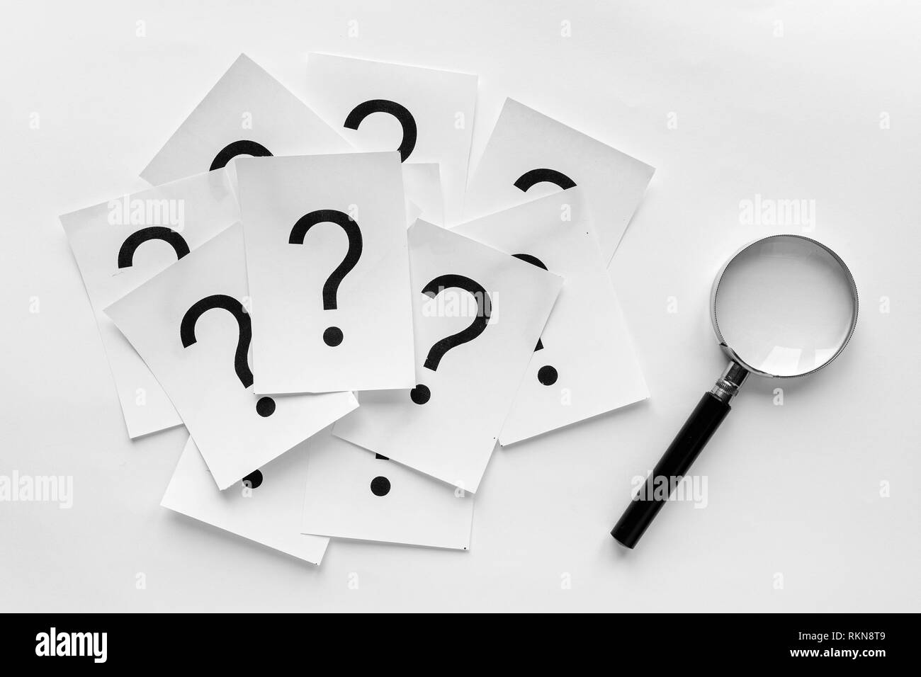 Background pattern of random question marks printed on white cards with ...