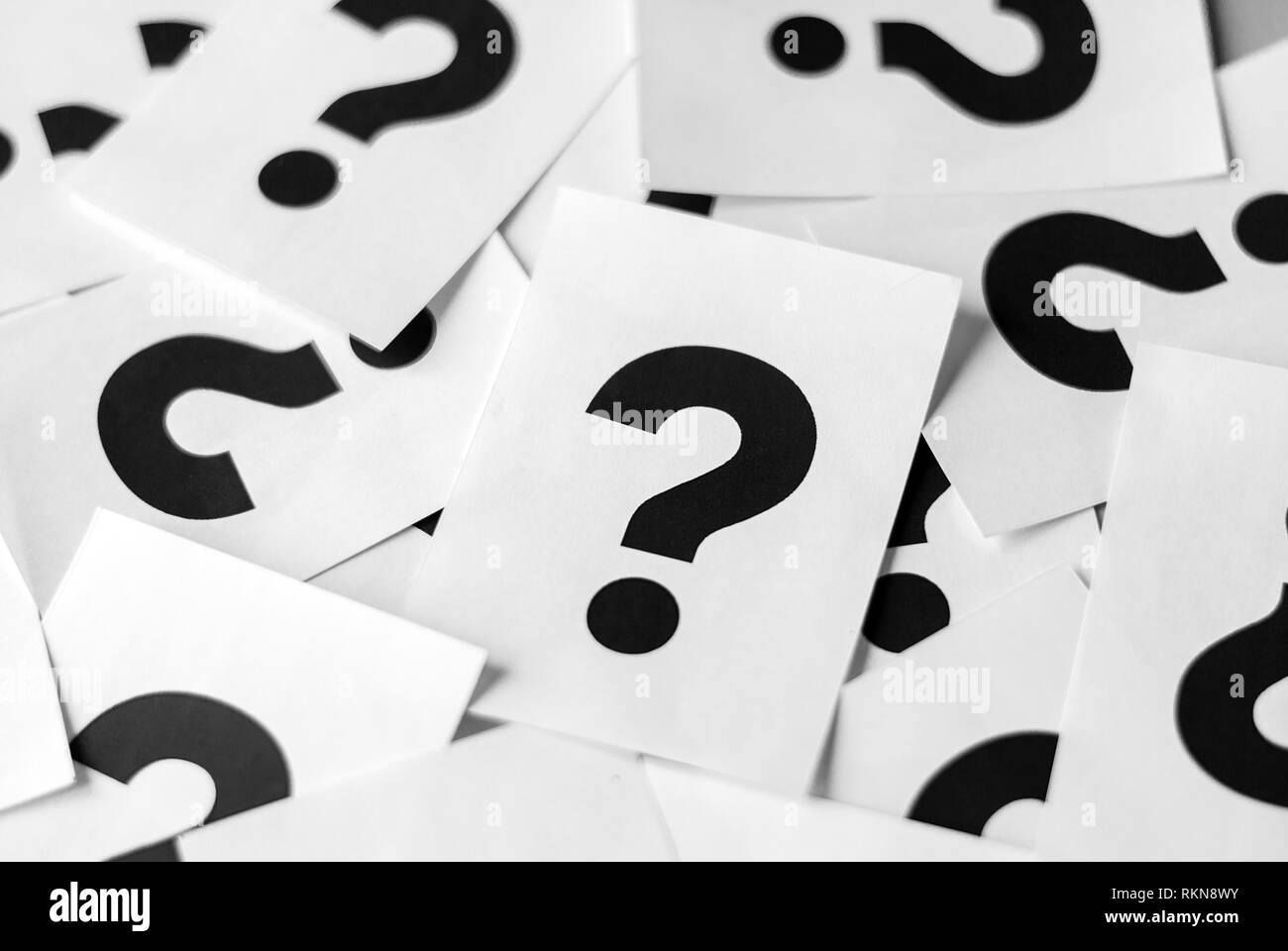 Pile of white cards with black question marks in close-up, full frame ...