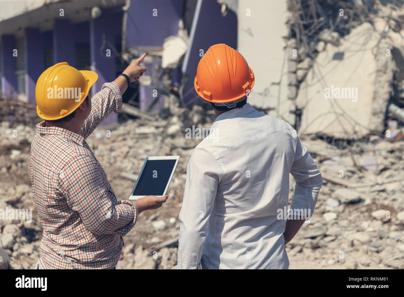 Engineer architect and worker operation control demolish old building ...