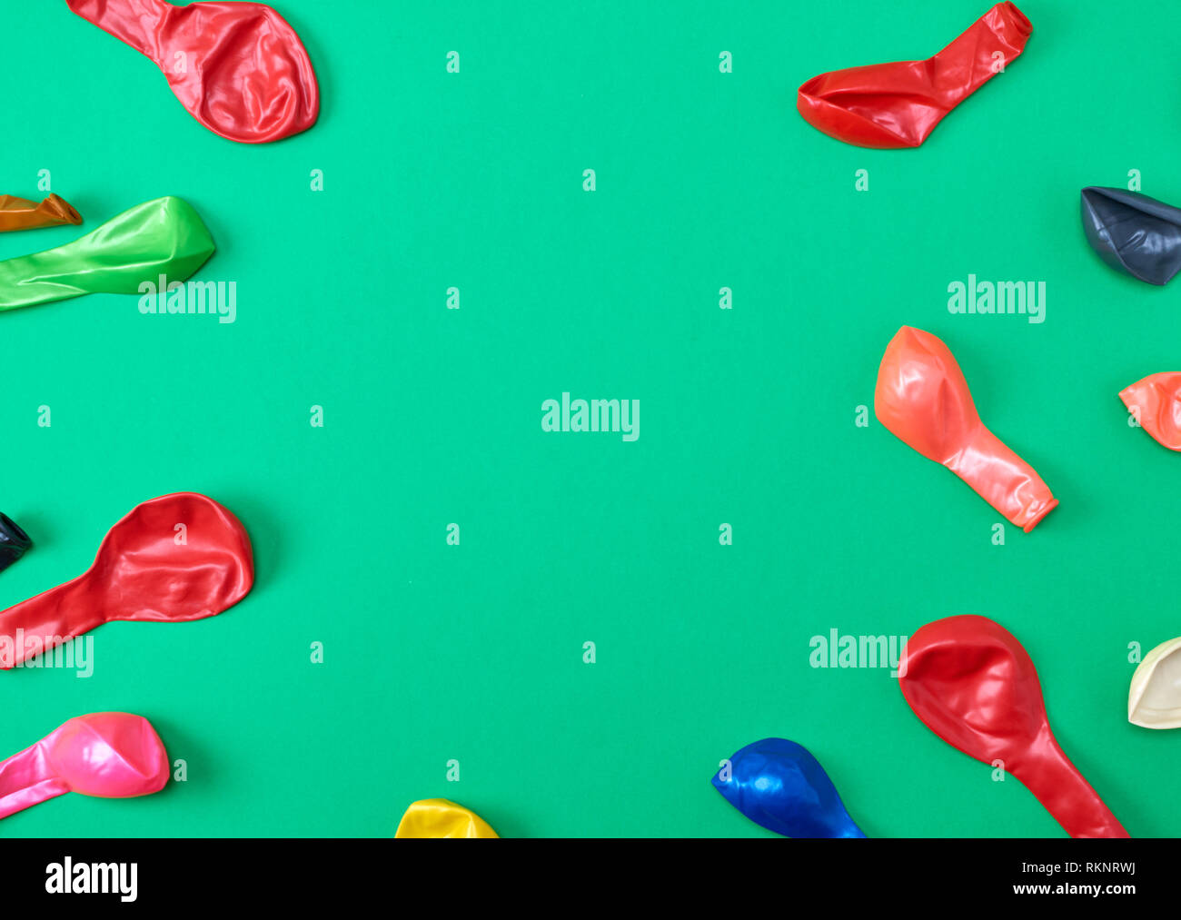 colorful deflated balloons on a green background, copy space Stock ...