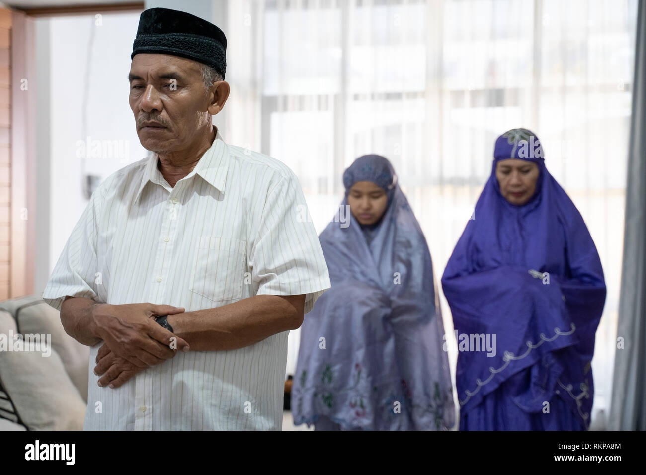 family members praying in congregation at the prayer room Stock Photo ...