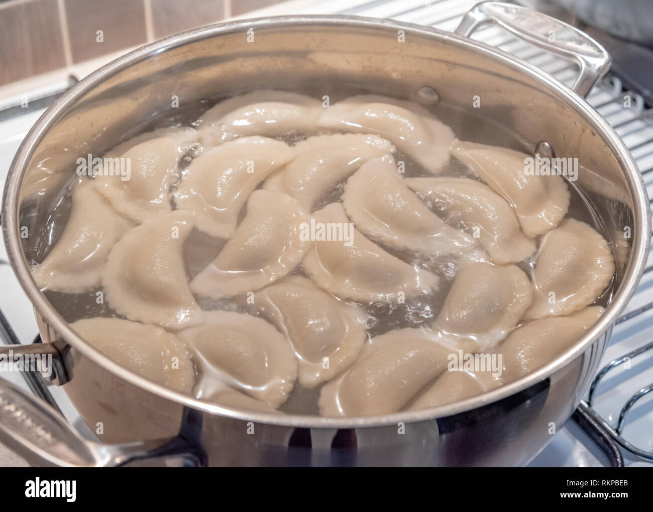 Pierogi boiling in a pot of water Stock Photo - Alamy