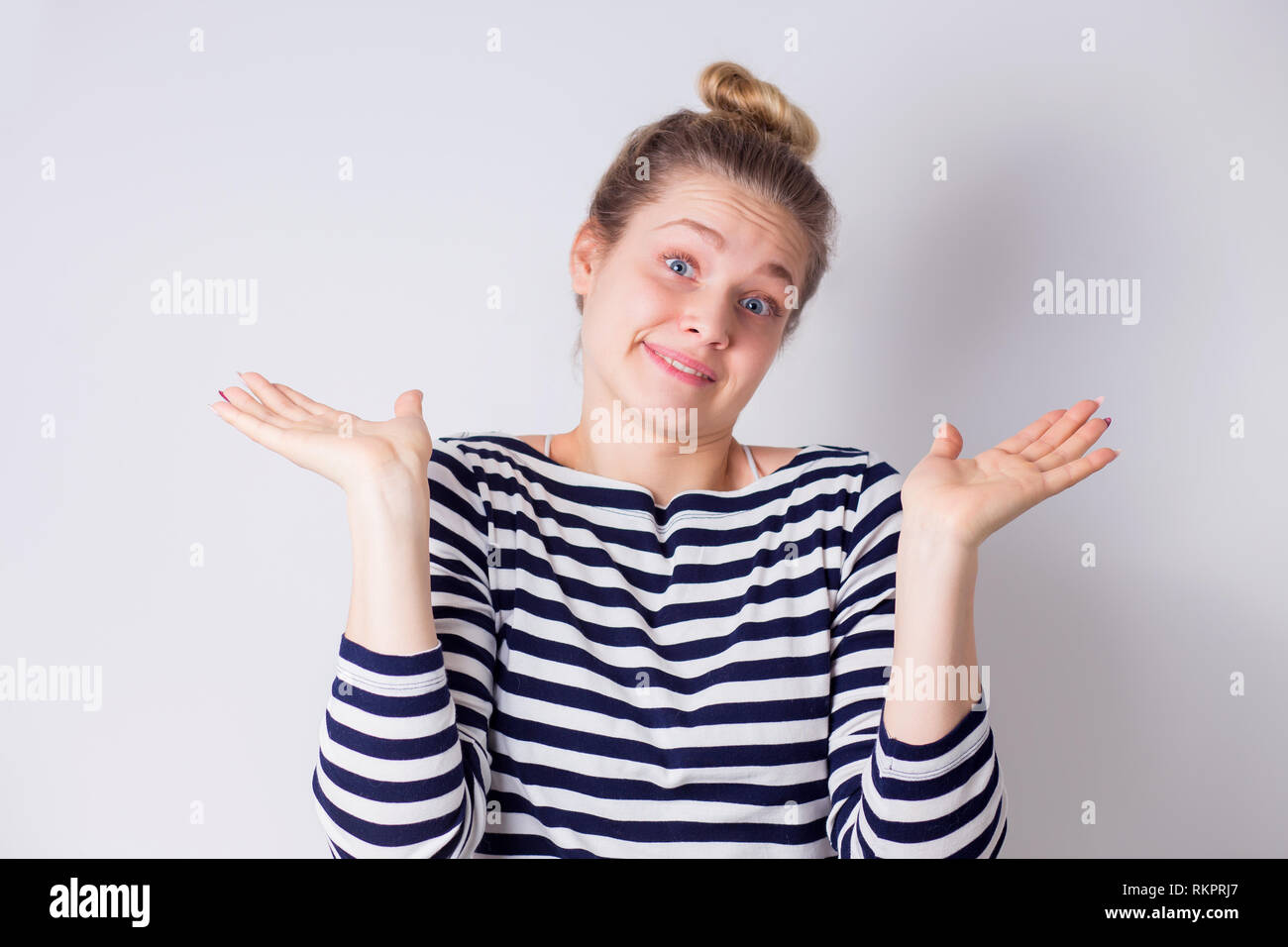 Portrait of confused and upset clumsy cute and silly woman shrugging ...